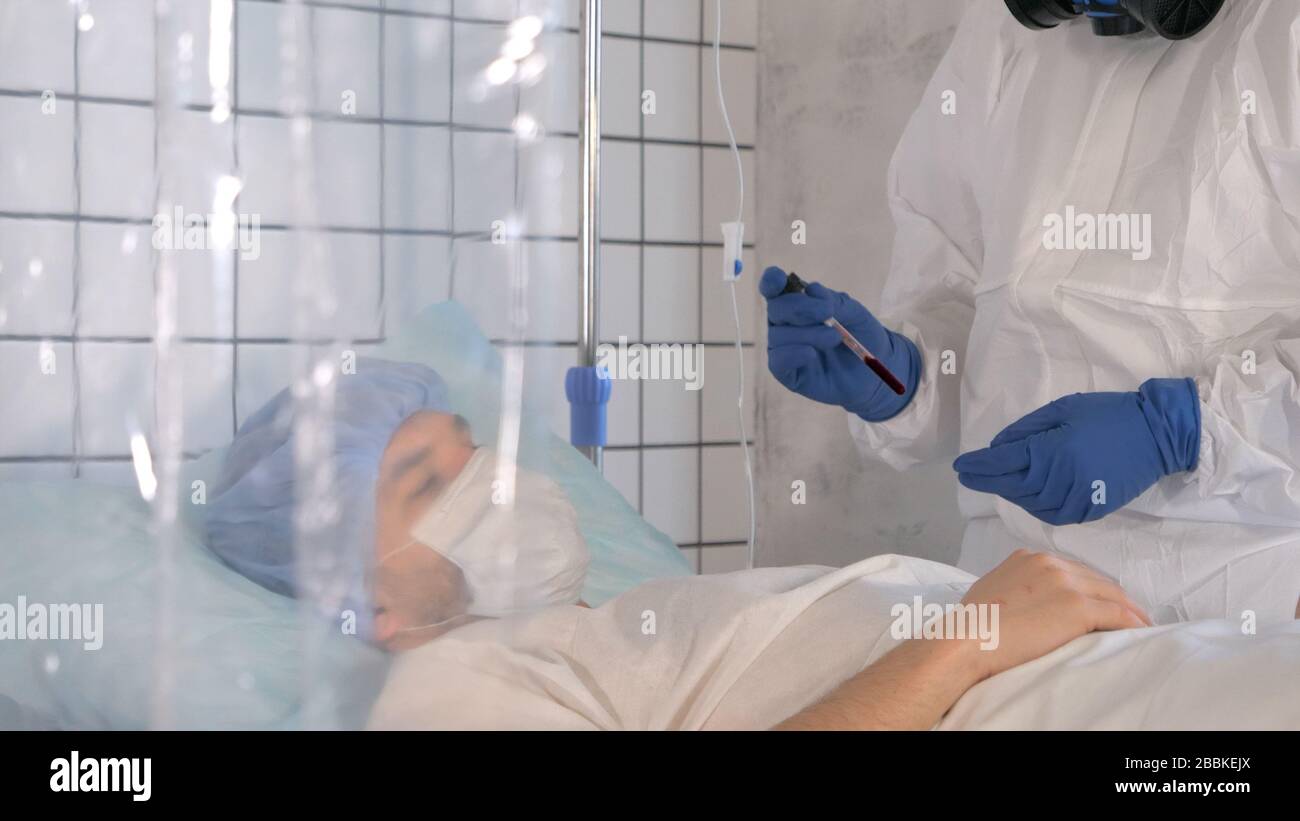 Doctor drawing blood sample from arm for blood test Stock Photo - Alamy