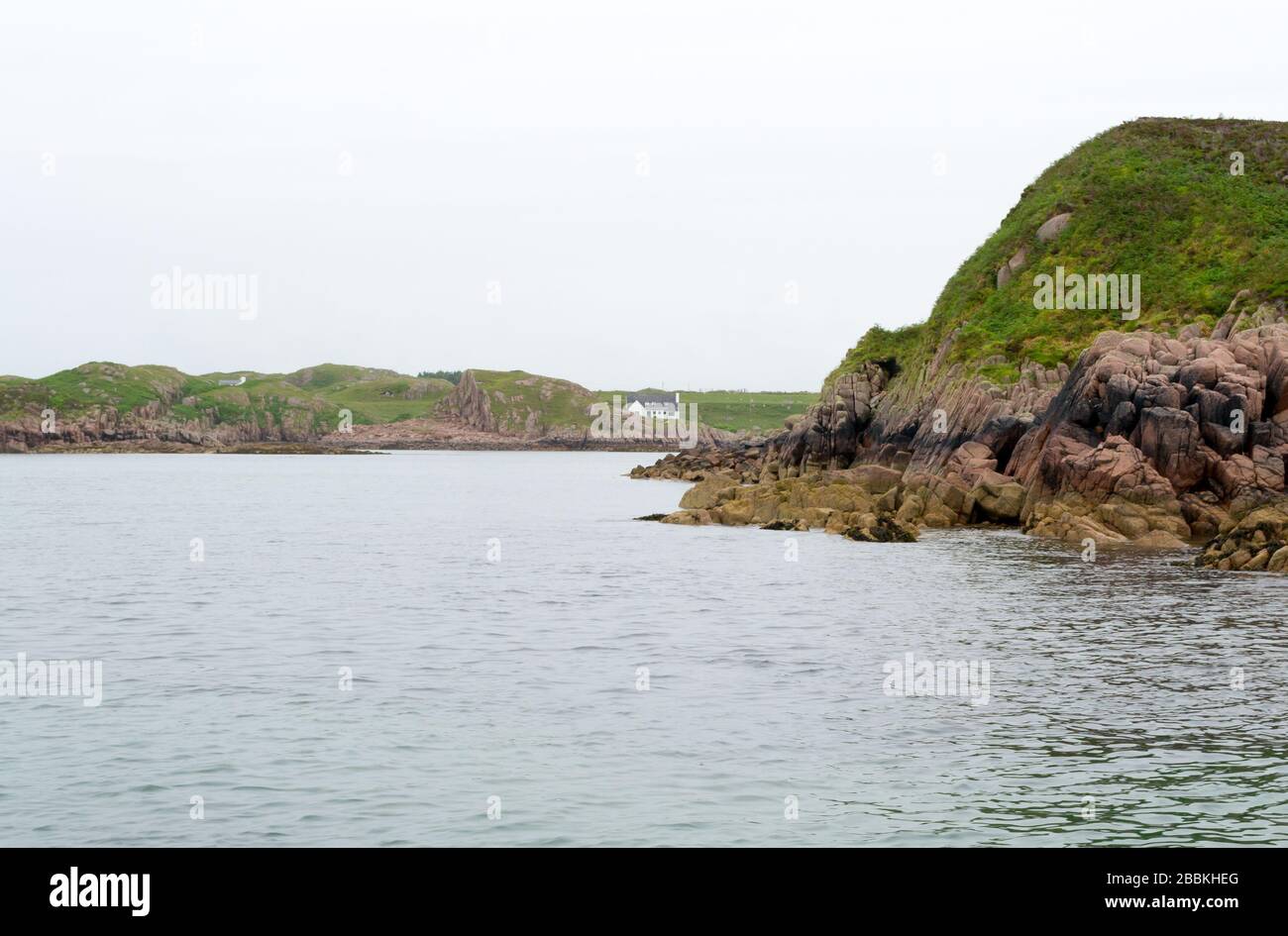 Textured volcanic rocks emerging from the water surface in the northern ...