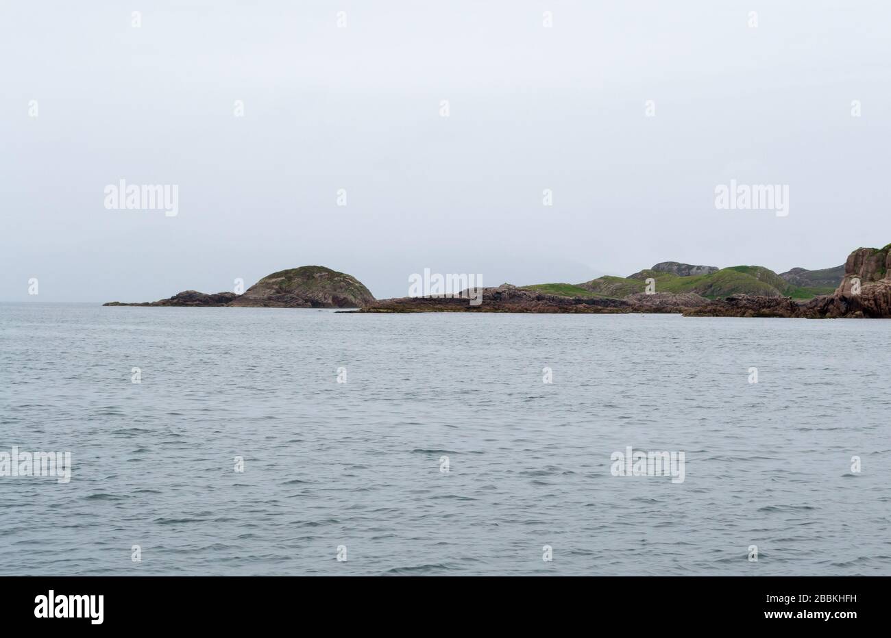 Textured volcanic rocks emerging from the water surface in the northern ...