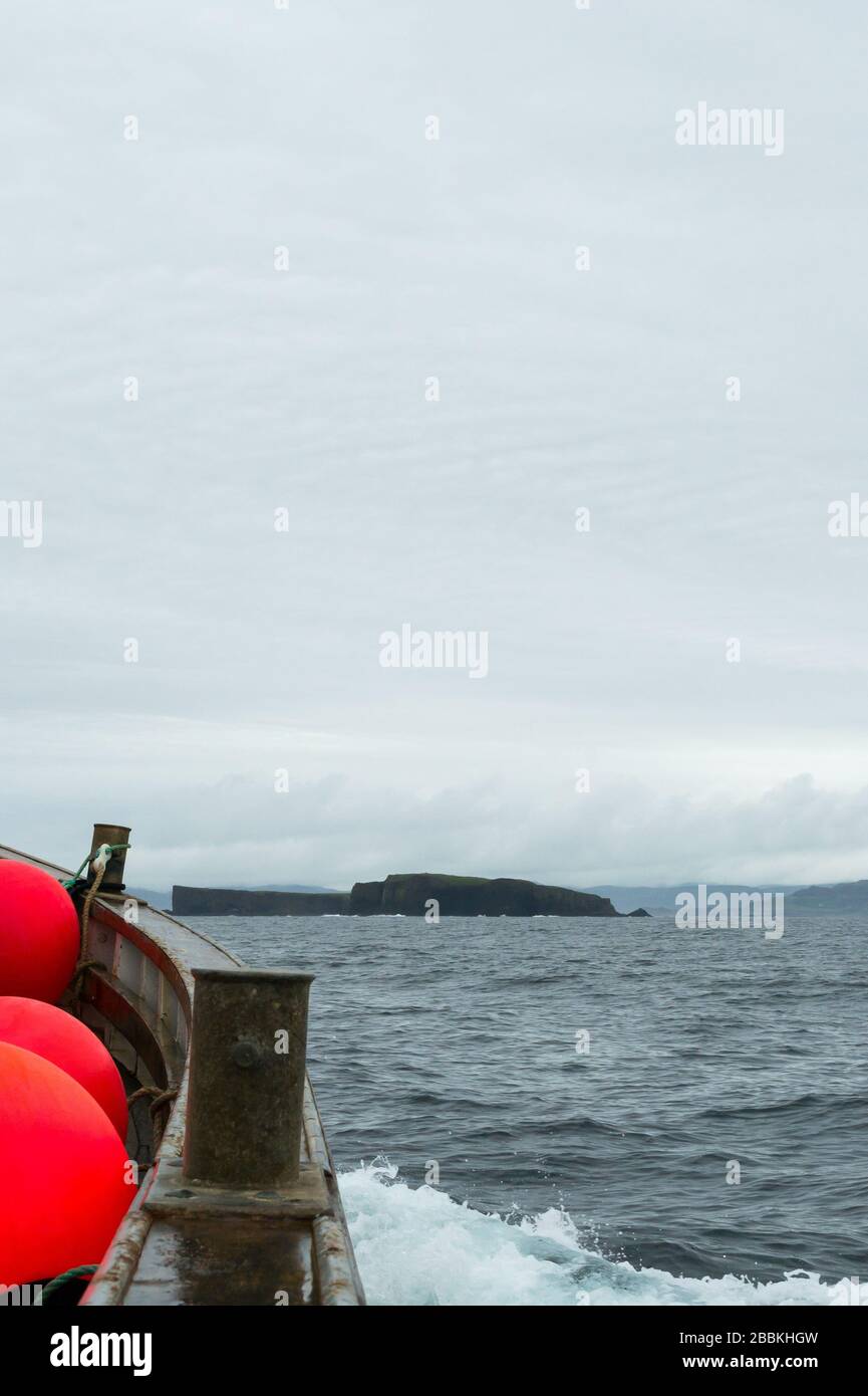 Staffa island seen from the ferry boat. It is a wild little isle closed ...