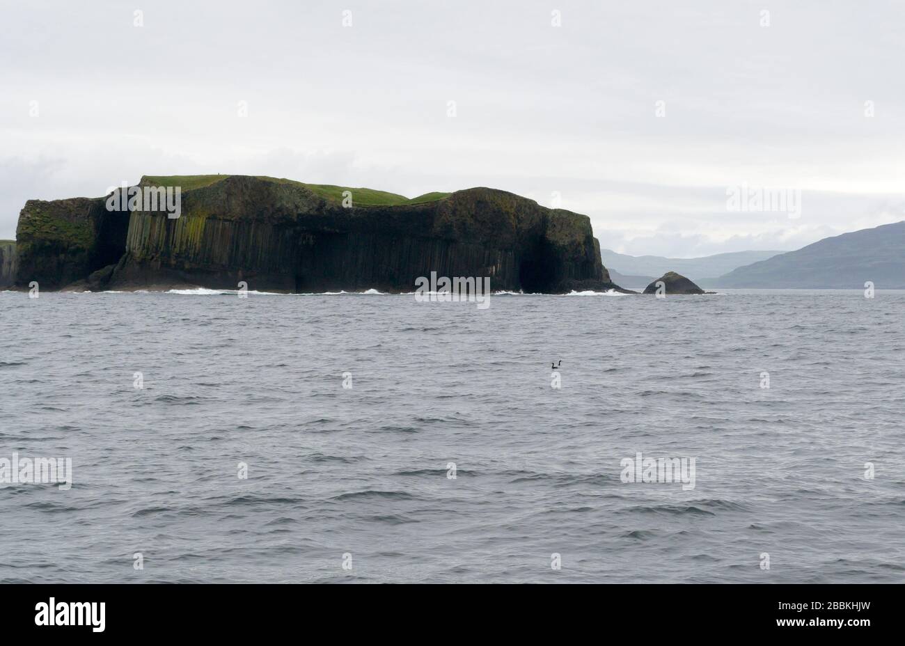 Staffa island seen from the ferry boat. It is a wild little isle closed ...
