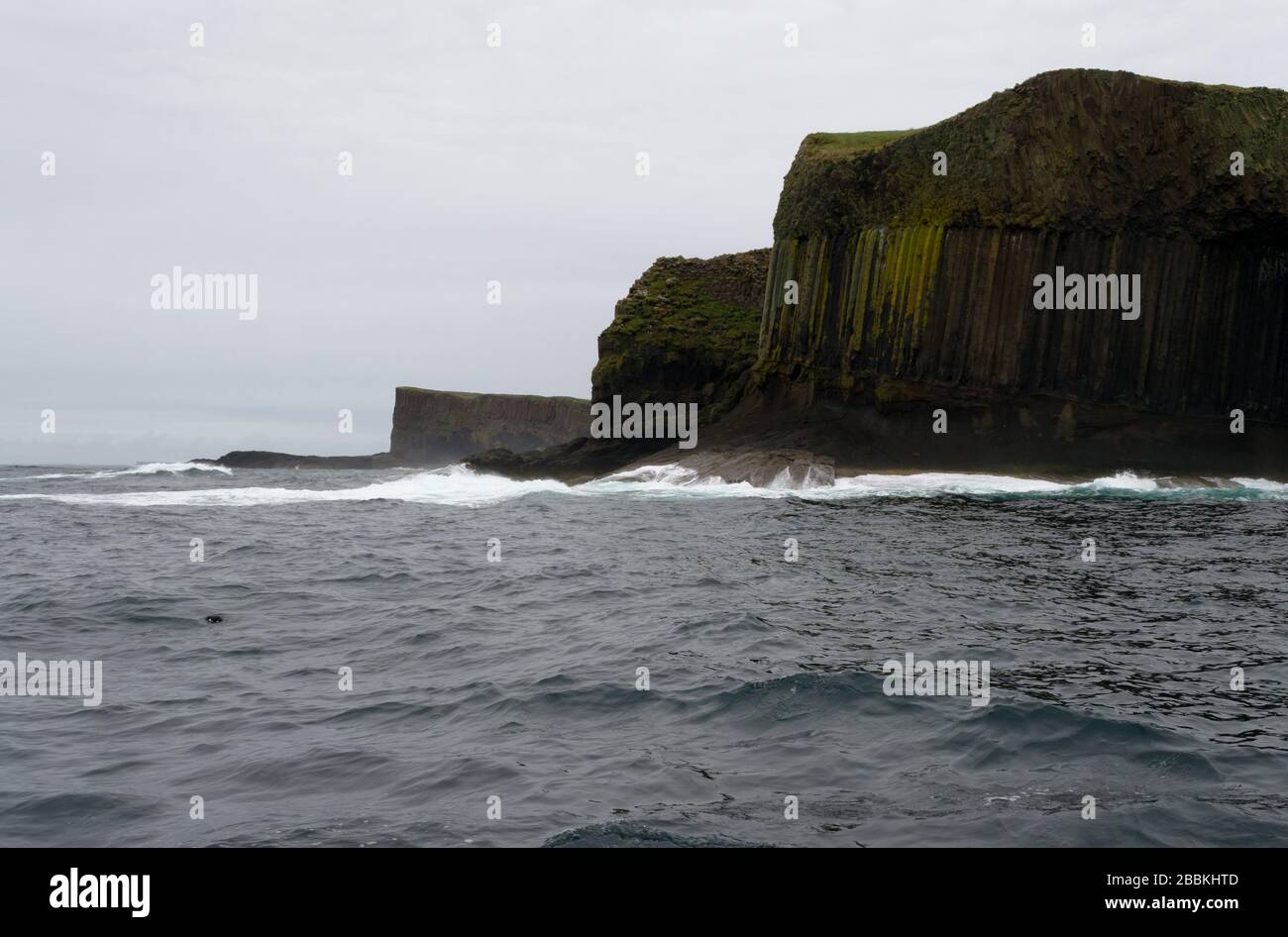 Staffa island seen from the ferry boat. It is a wild little isle closed ...