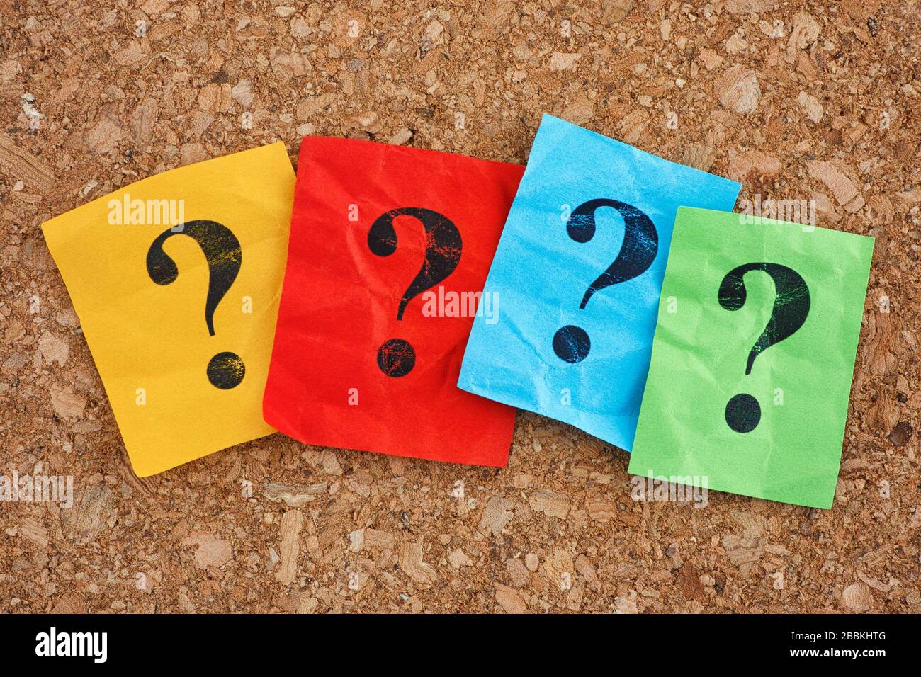 Colorful paper notes with question marks on a cork board. Closeup Stock ...