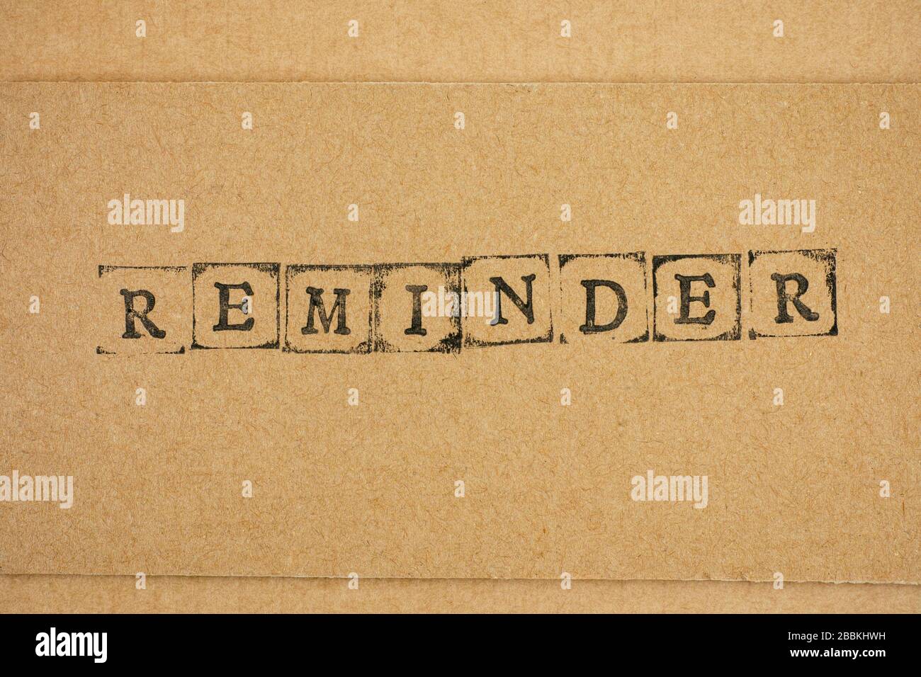 Cardboard with word Reminder made by black alphabet stamps Stock Photo ...