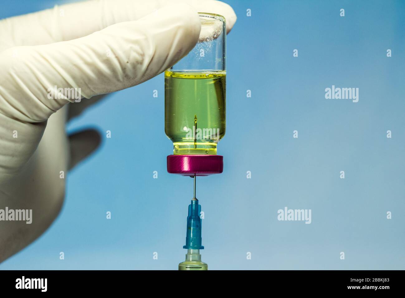 Hand holding syringe and medicine vial prepare for injection with ...