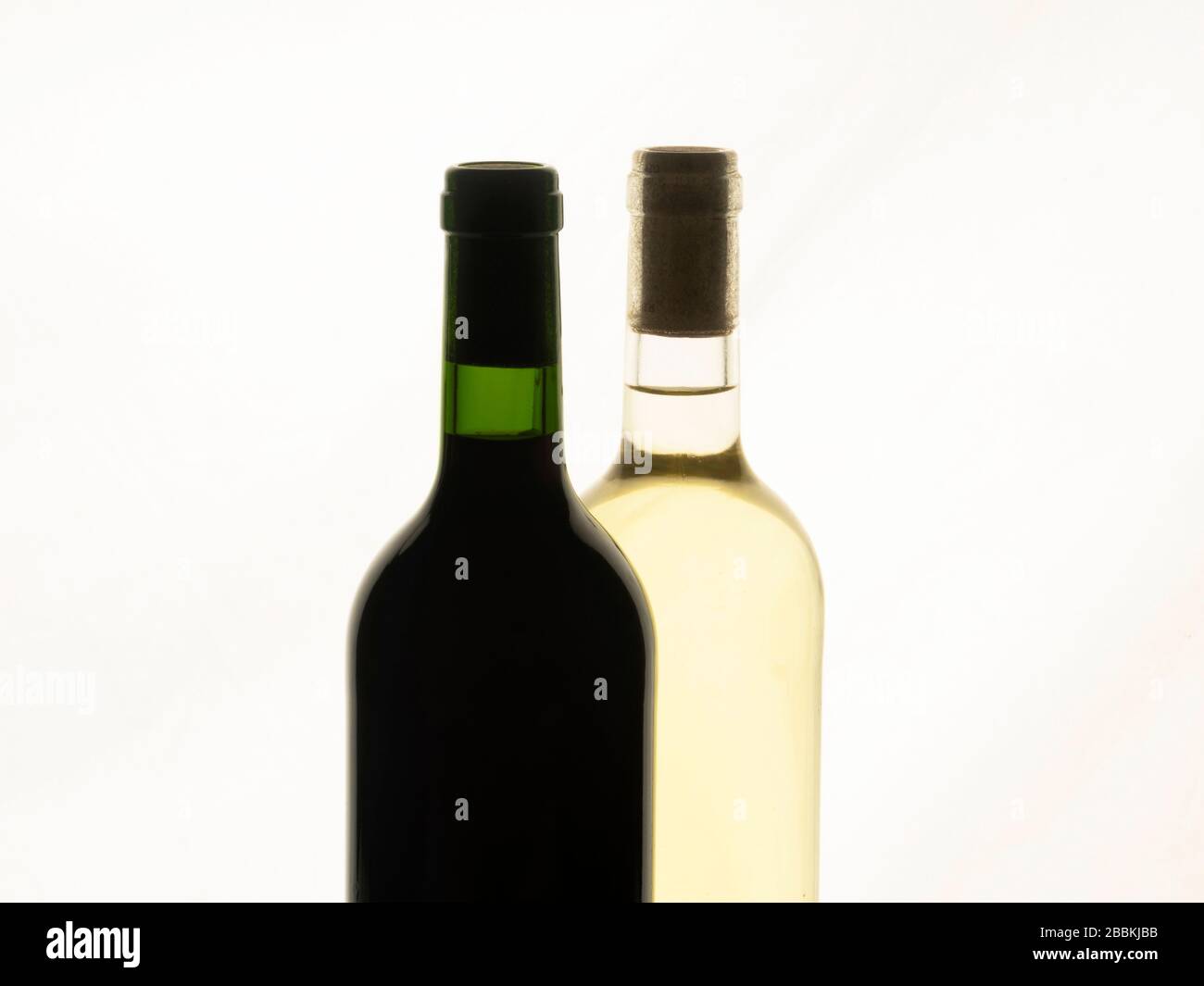 Close-up shot of two unlabelled wine bottles against white background ...