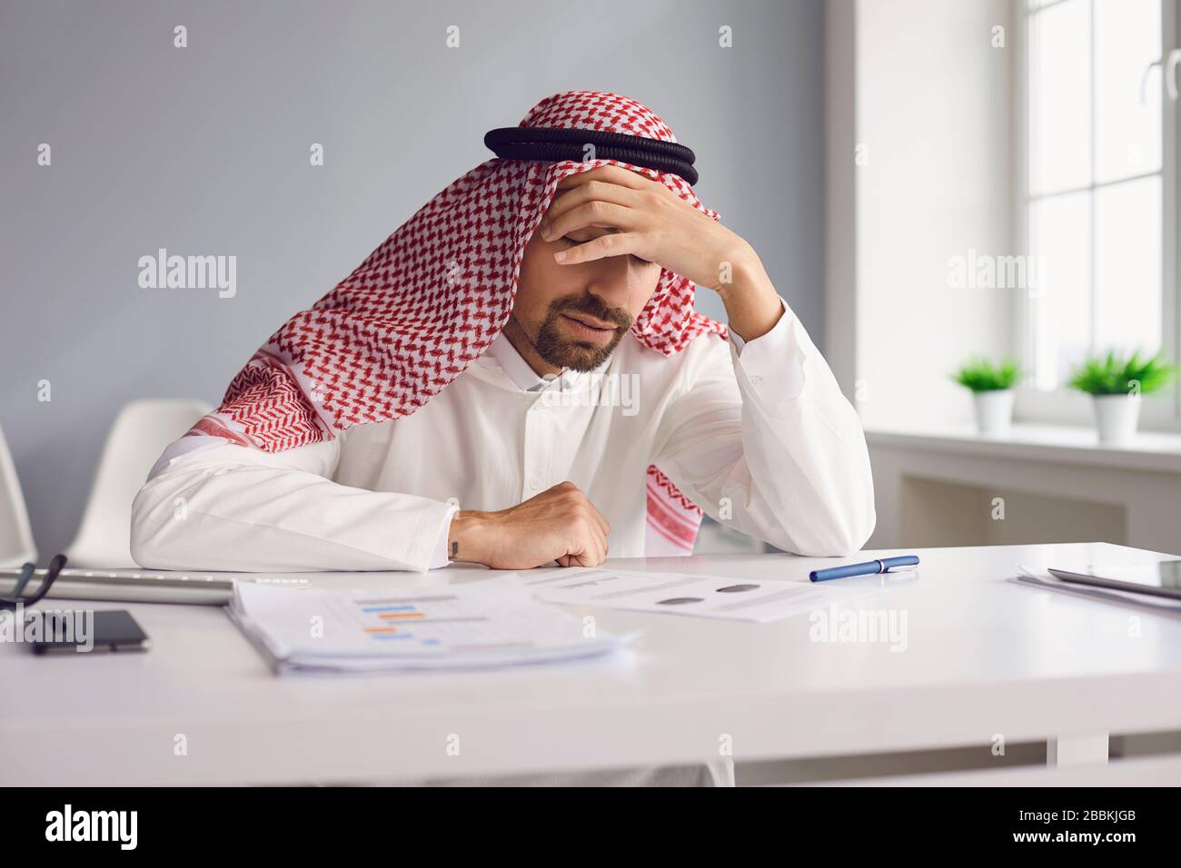Arab man upset unhappy tired depressed covered his face with his hands ...