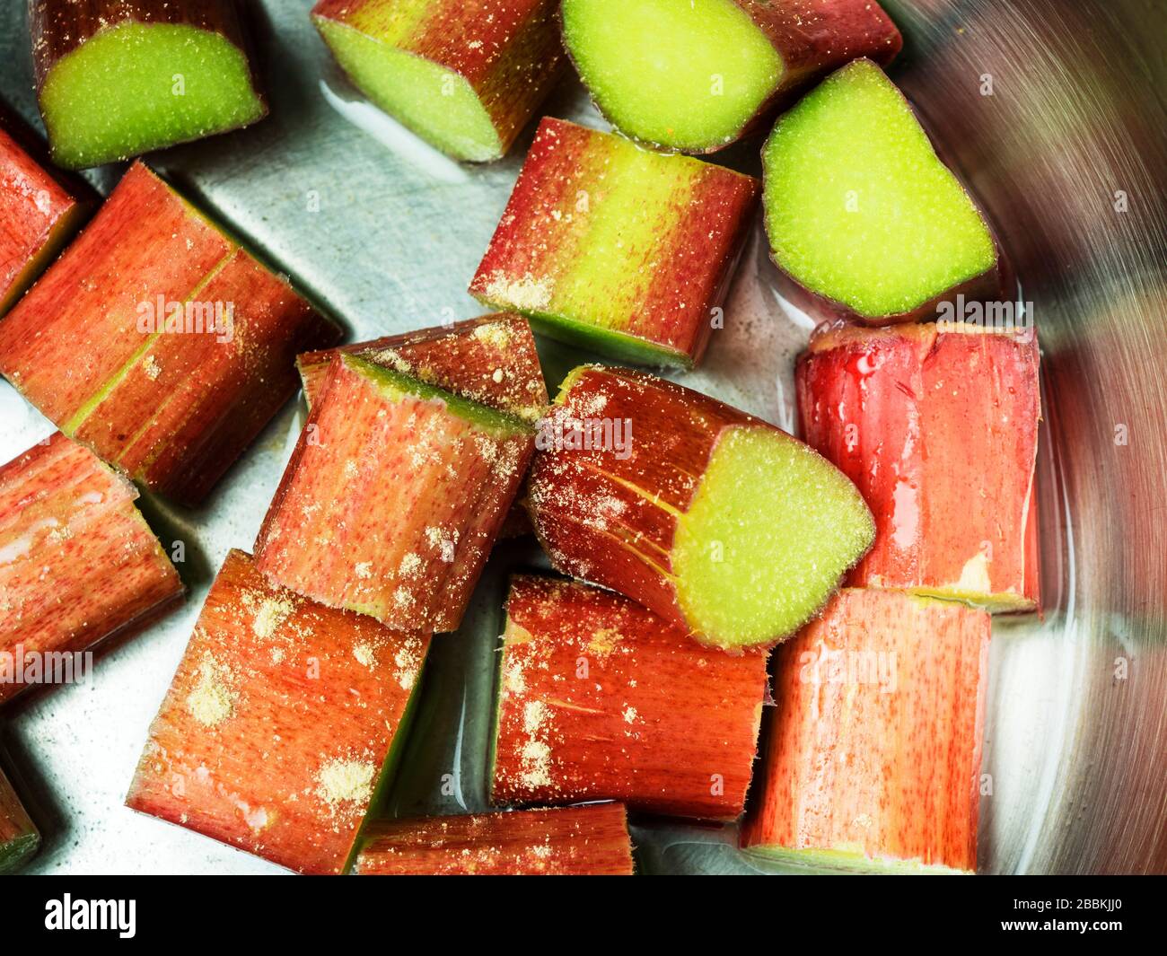 Rhubarb pieces sprinked with a pinch of ground ginger in a stainless ...