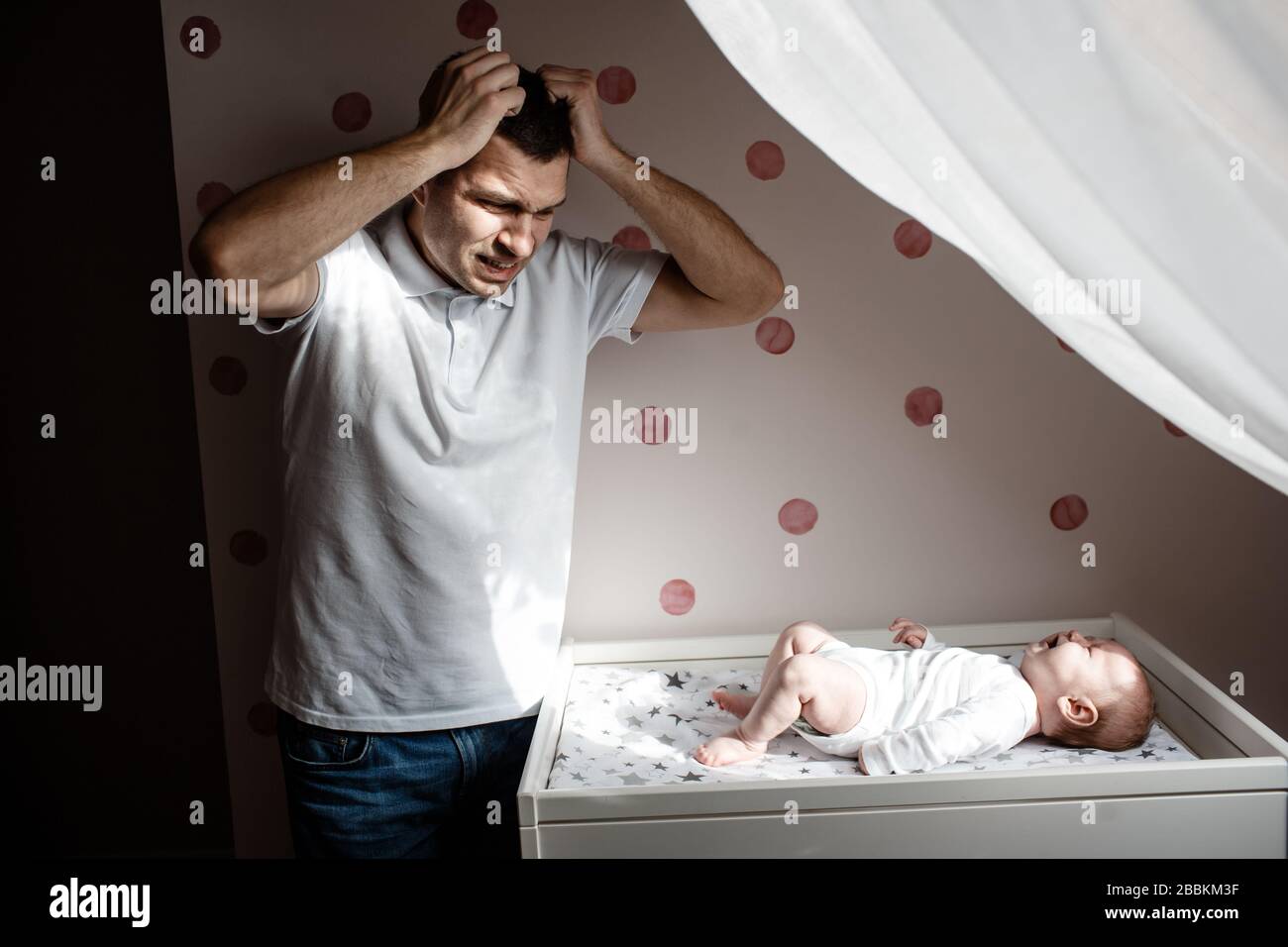 Father and little kid in the nursery. The first year of life ...