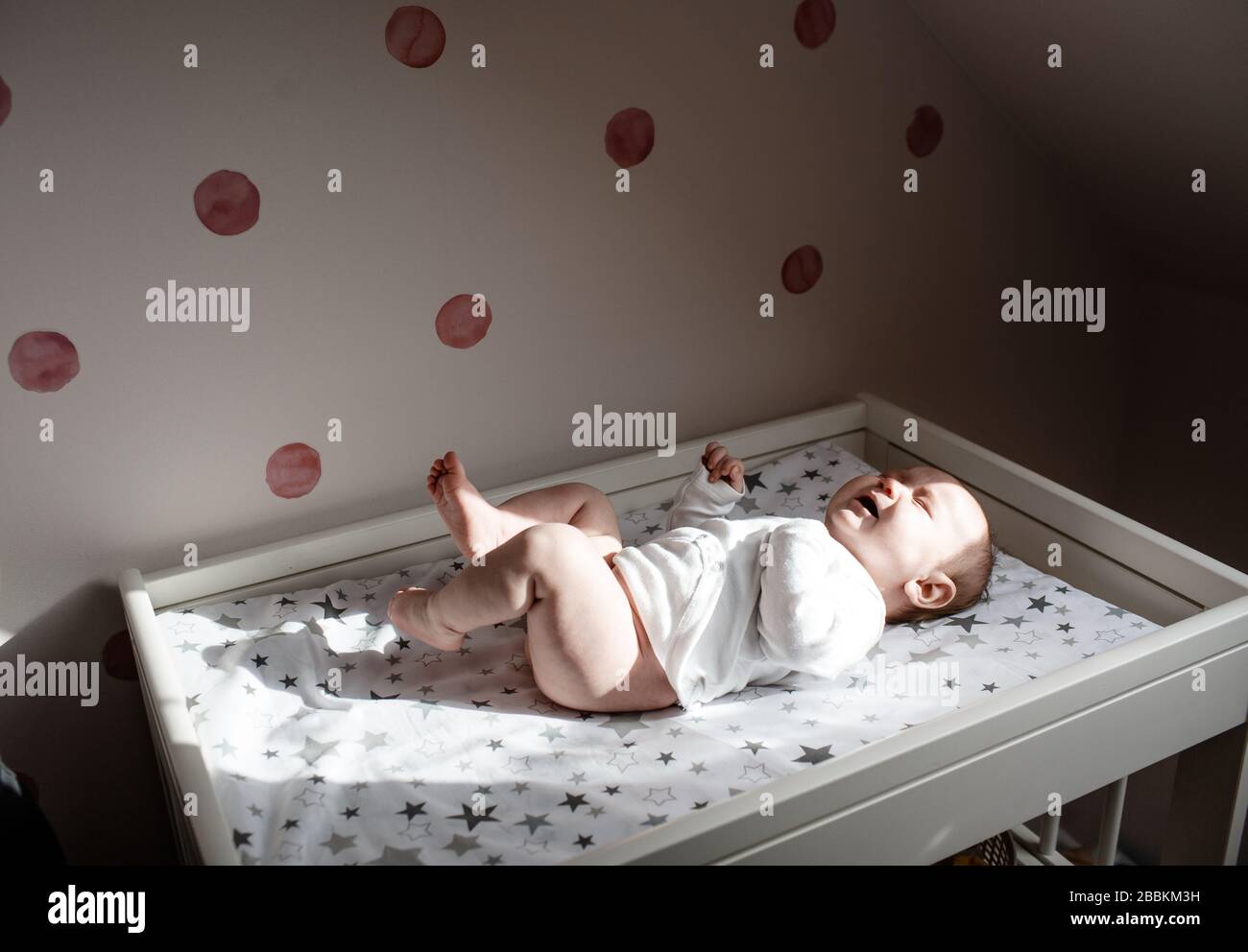A newborn is screaming on a changing table. Stomach pain, childhood ...