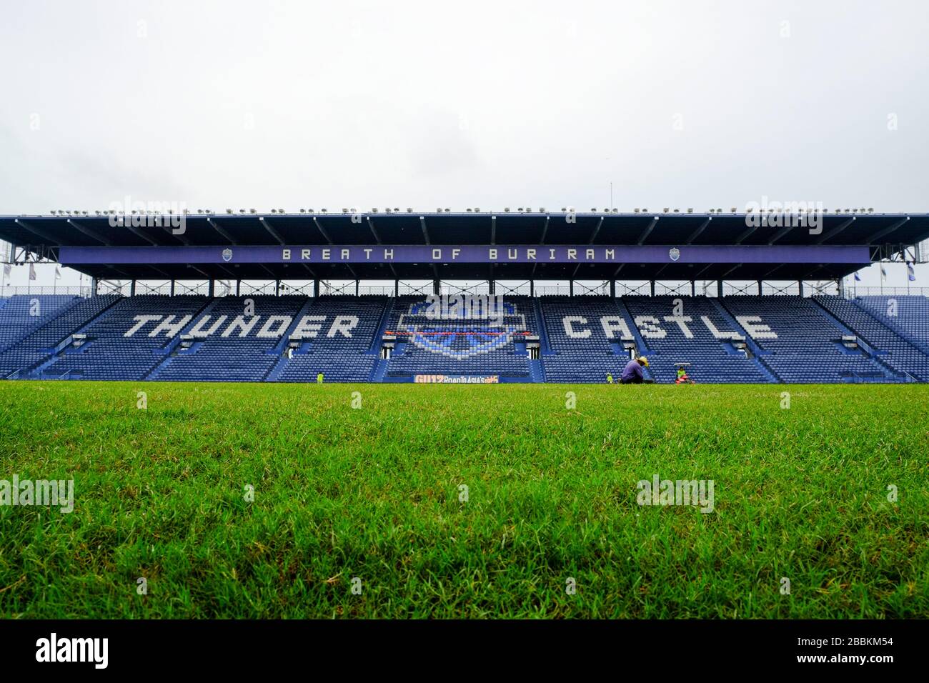 Navy blue amphitheater in football arena with green football pitch ...