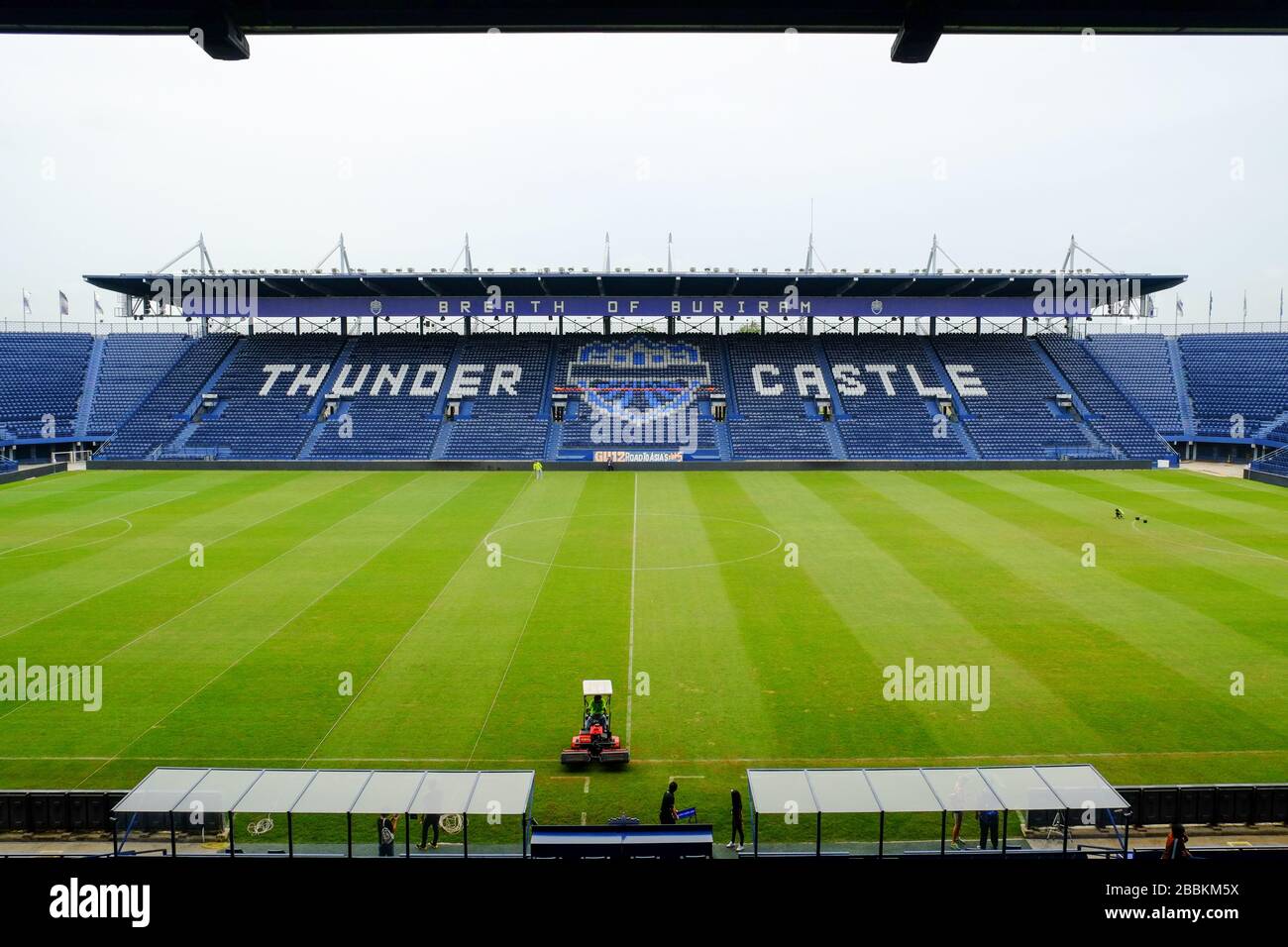 Navy blue amphitheater in football arena with green football pitch ...