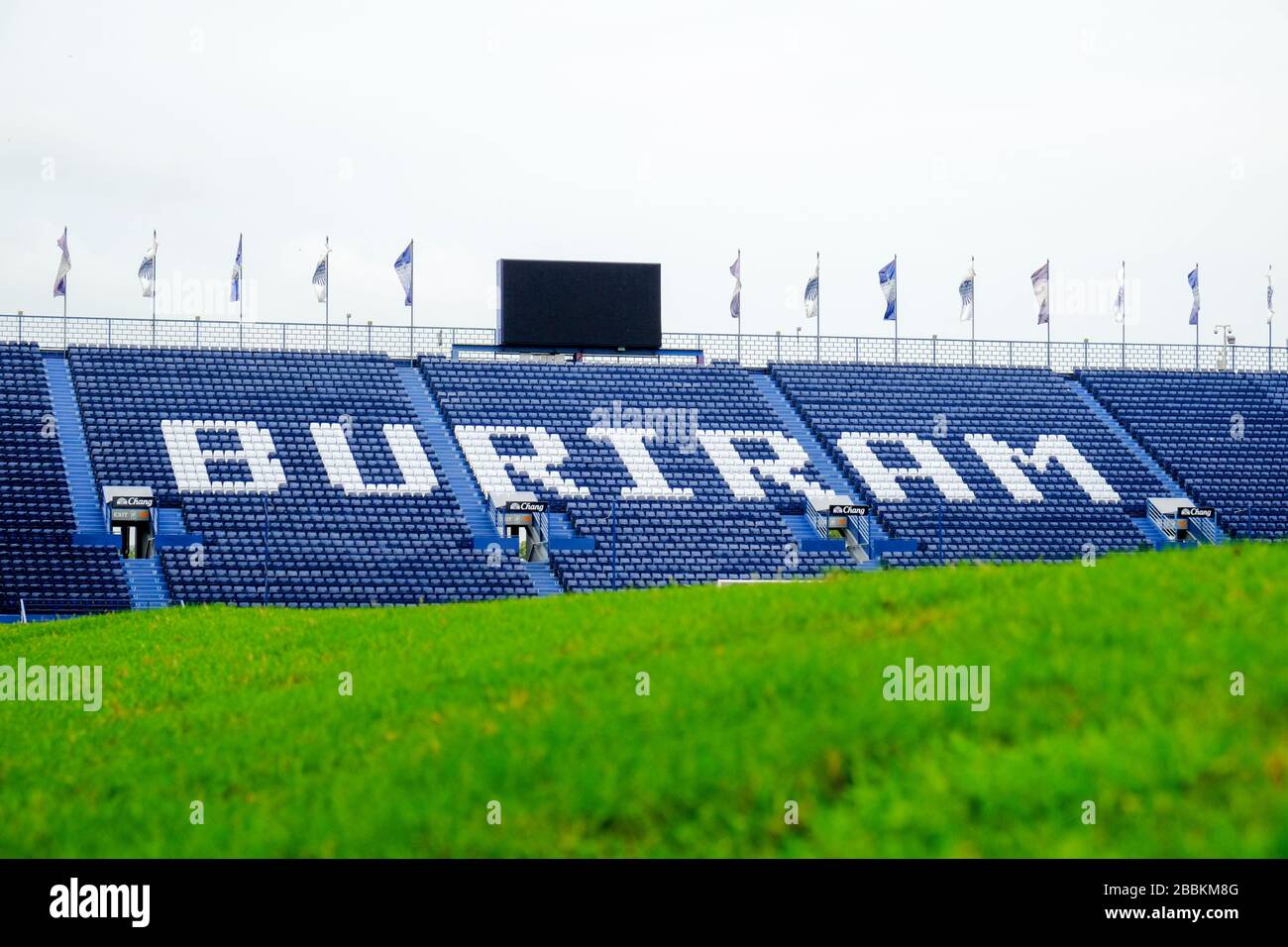 Navy blue amphitheater in football arena with green football pitch ...