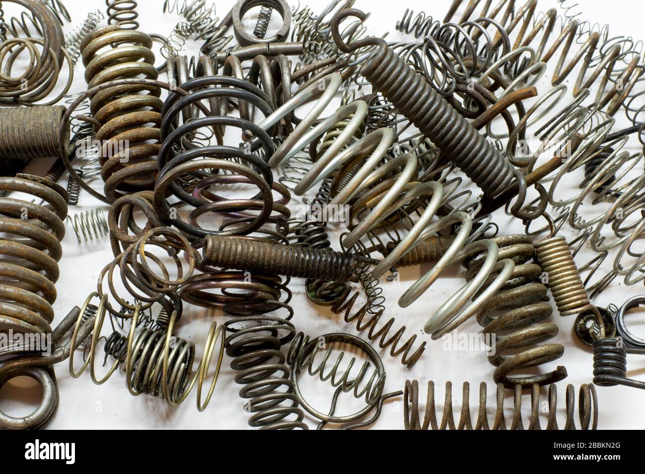 Close up of metal springs and coils on white background Stock Photo - Alamy