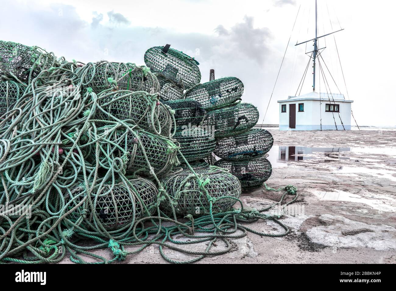 Dock littered with empty fishing baskets near a small building, Porto ...