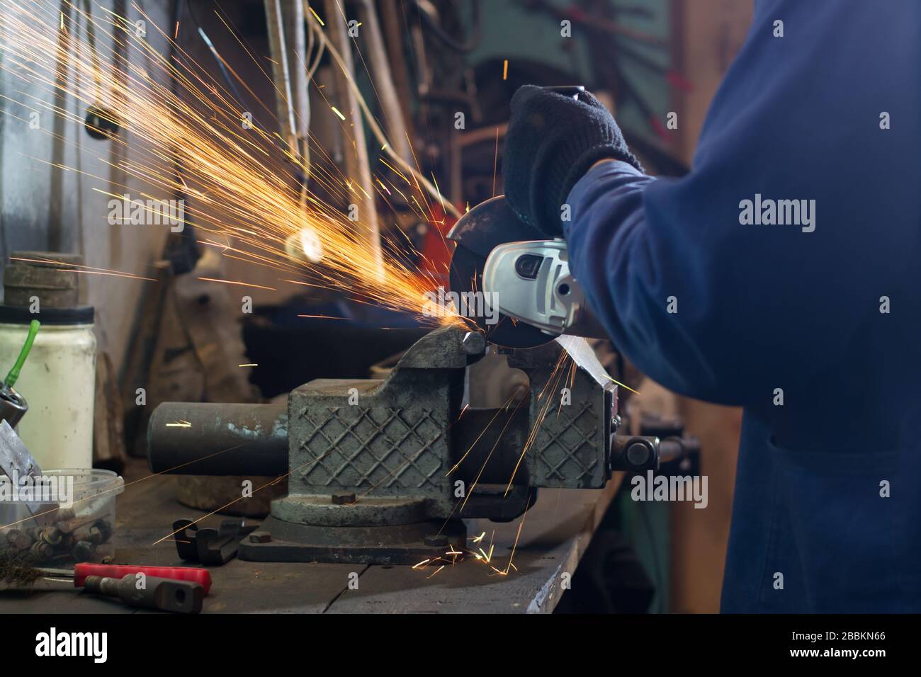 Photo of mechanic grinding metal plate in workshop Stock Photo - Alamy