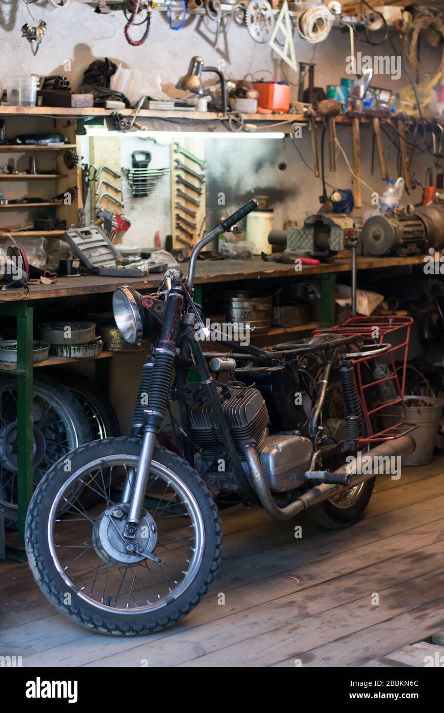 Old motorcycle, which needs to be repaired, in the workshop Stock Photo ...