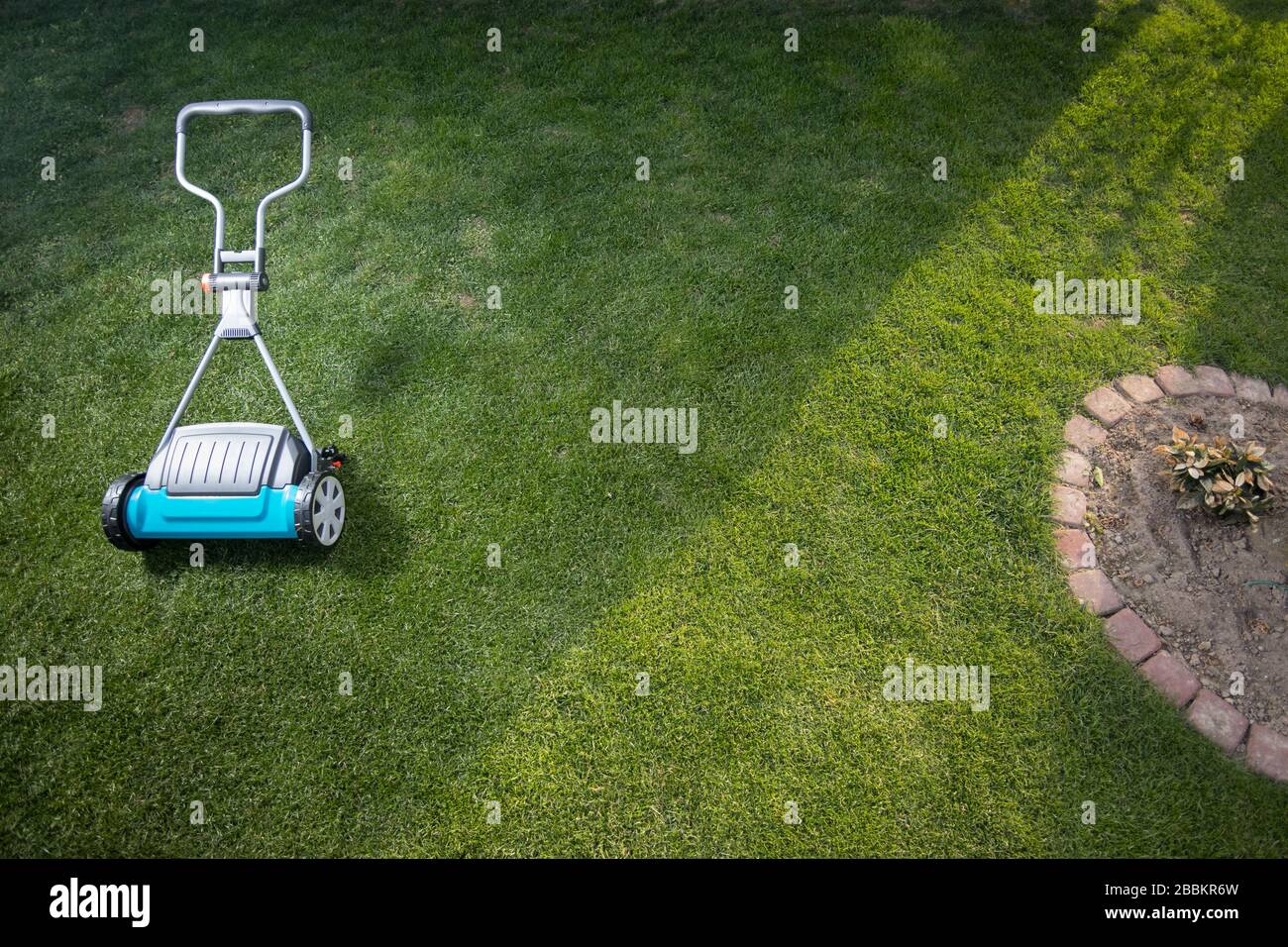 Lawnmover hand held machine. Hand lawn mower. Lawn mower on a green ...