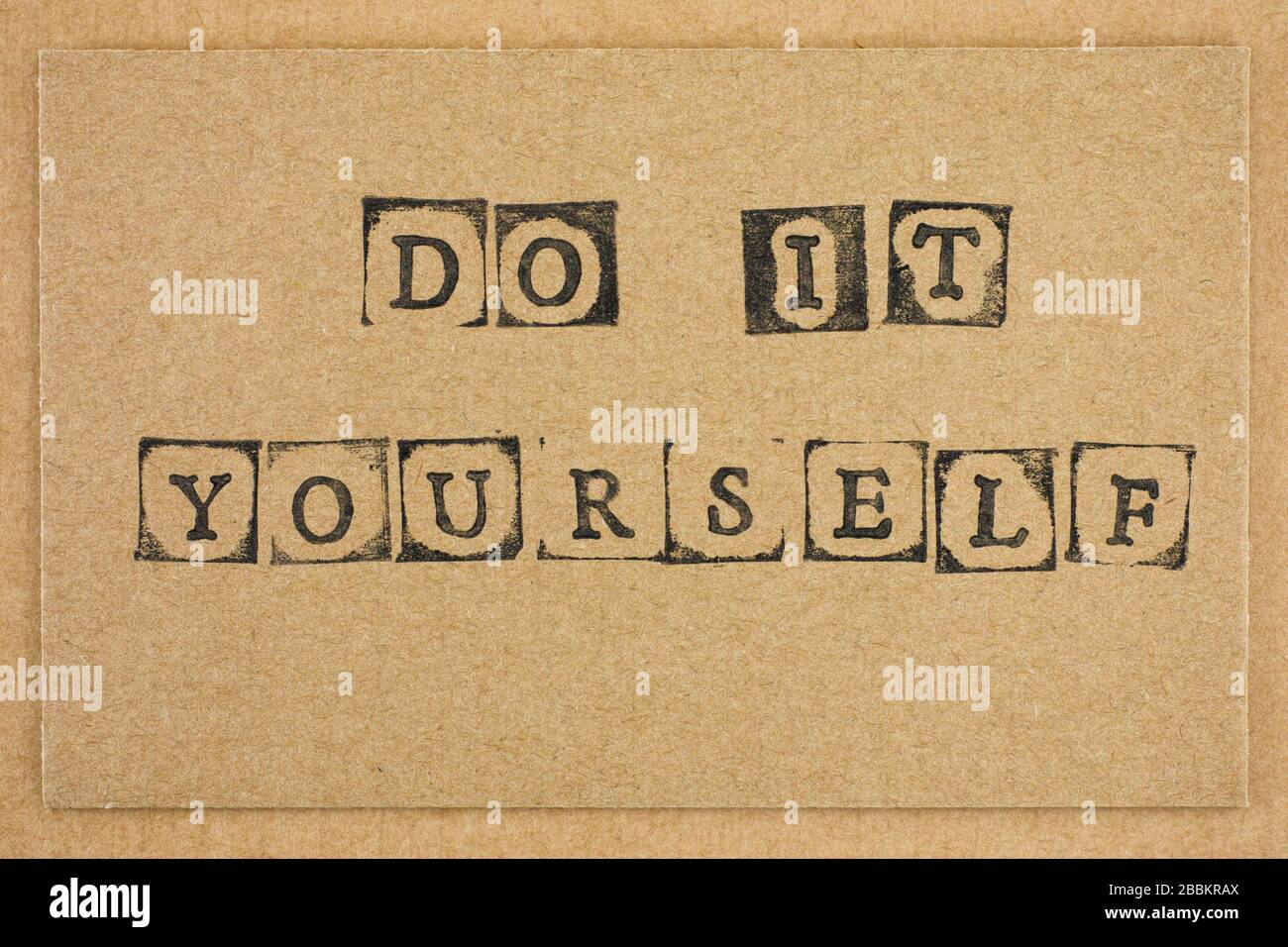 Cardboard with words Do It Yourself made by black alphabet stamps Stock ...
