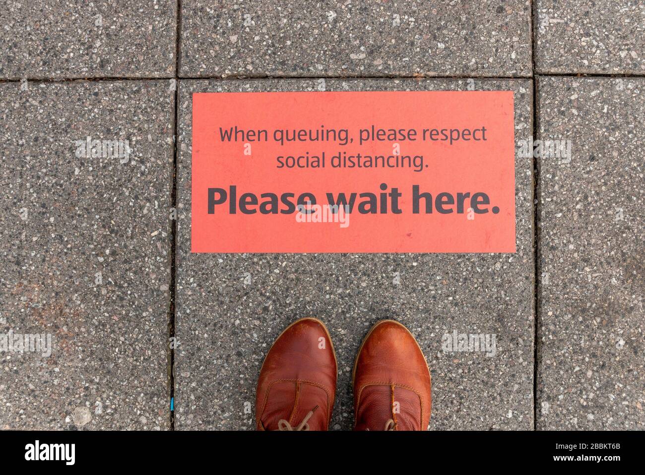 A close up view of taped off area on where to stand waiting to get into ...