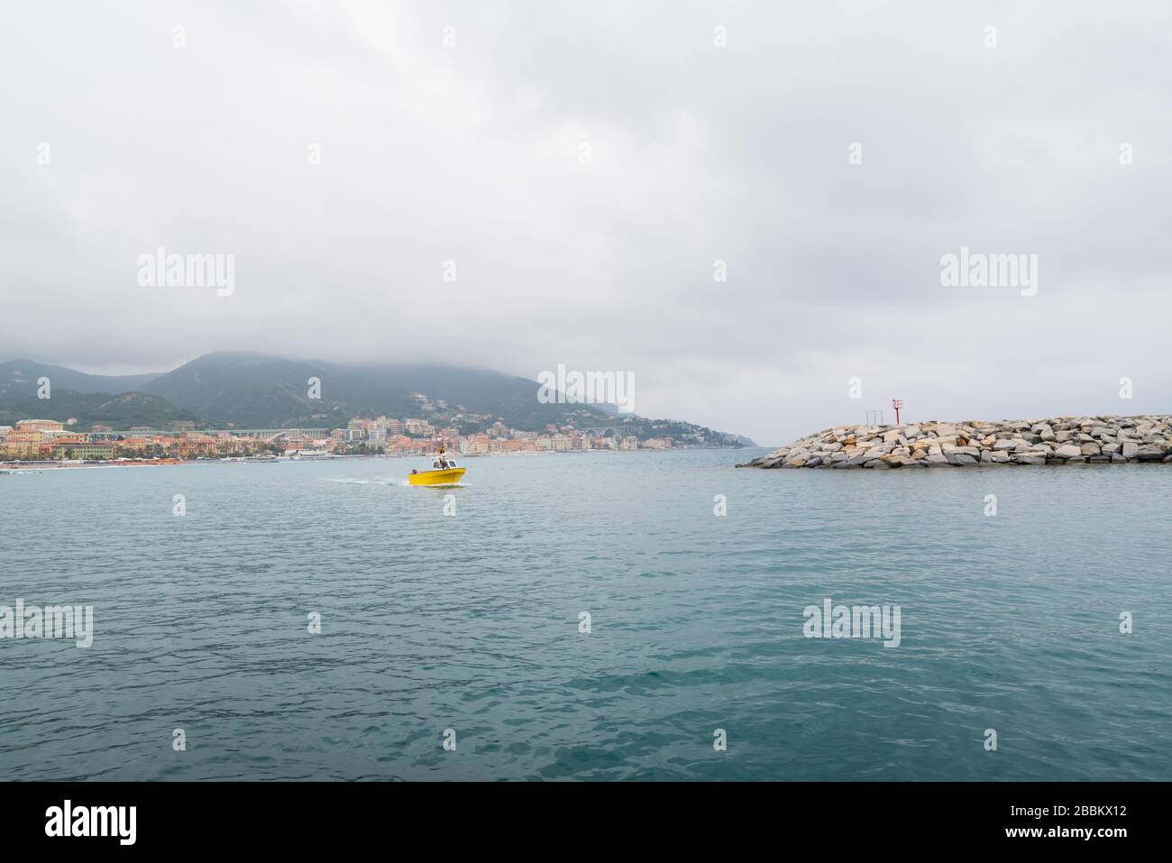 Yellow fishing boat while returning to the port of Varazze, Liguria ...