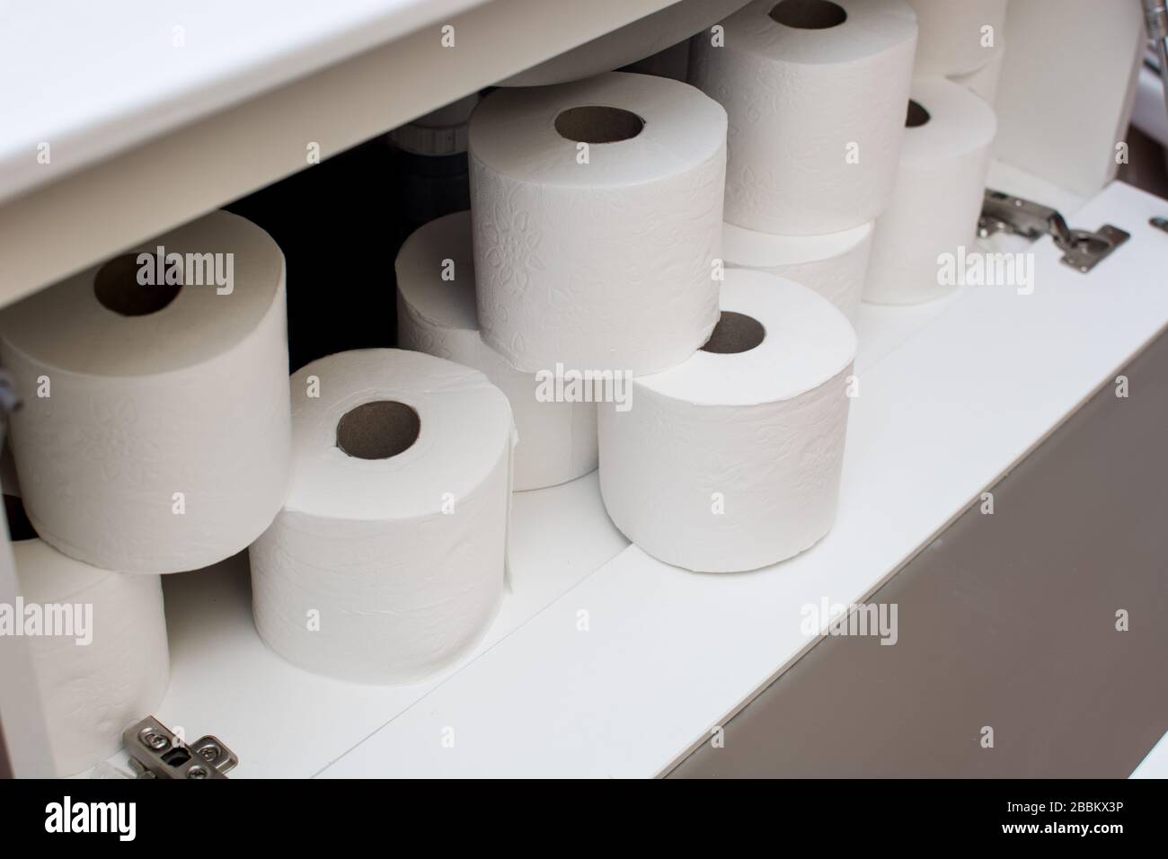 Paper rolls in bathroom furniture Stock Photo - Alamy