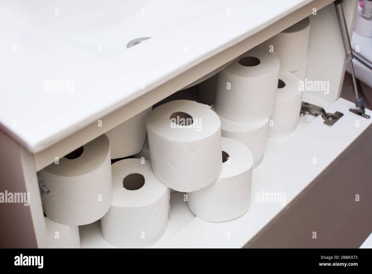 Paper rolls in bathroom furniture Stock Photo - Alamy