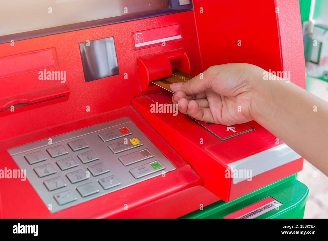 Hand insert credit card to ATM bank cash machine for withdraw money ...