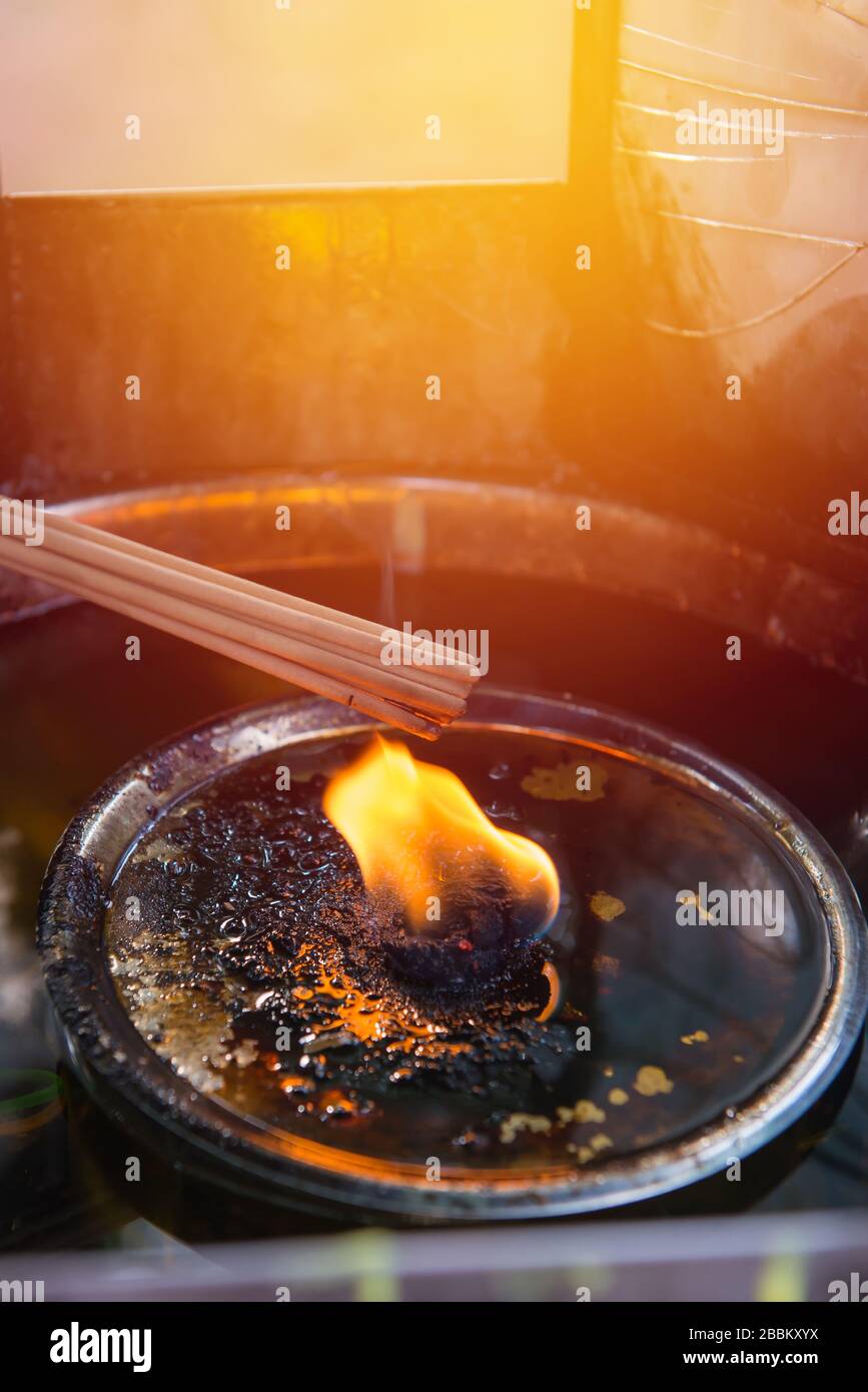 Burning red incense sticks in temple at Thailand Stock Photo - Alamy