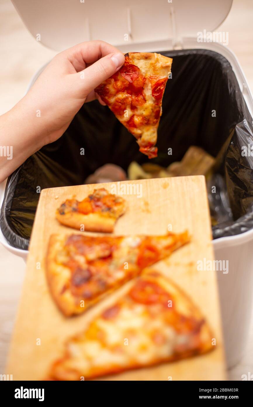 Woman hands throwing food into the trash, bin, waste of food, food ...