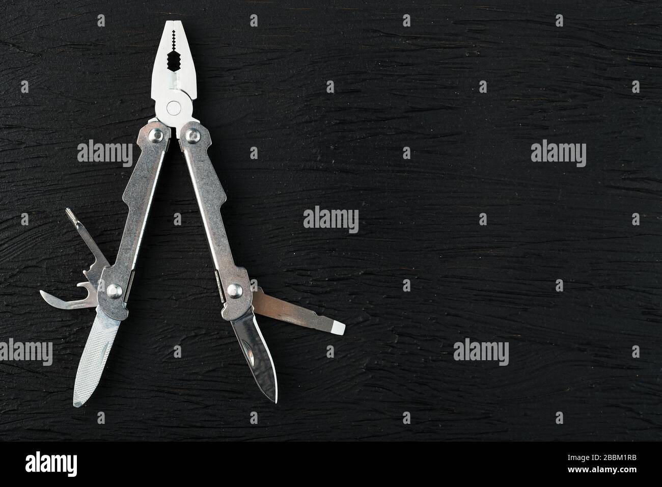 Multitool is a multi-functional tool on a black background. The concept ...