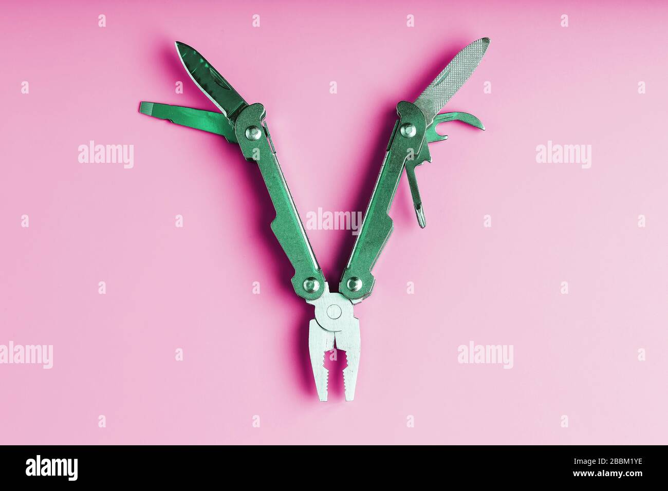 Multitool is a multi-functional tool on a pink background. The concept ...
