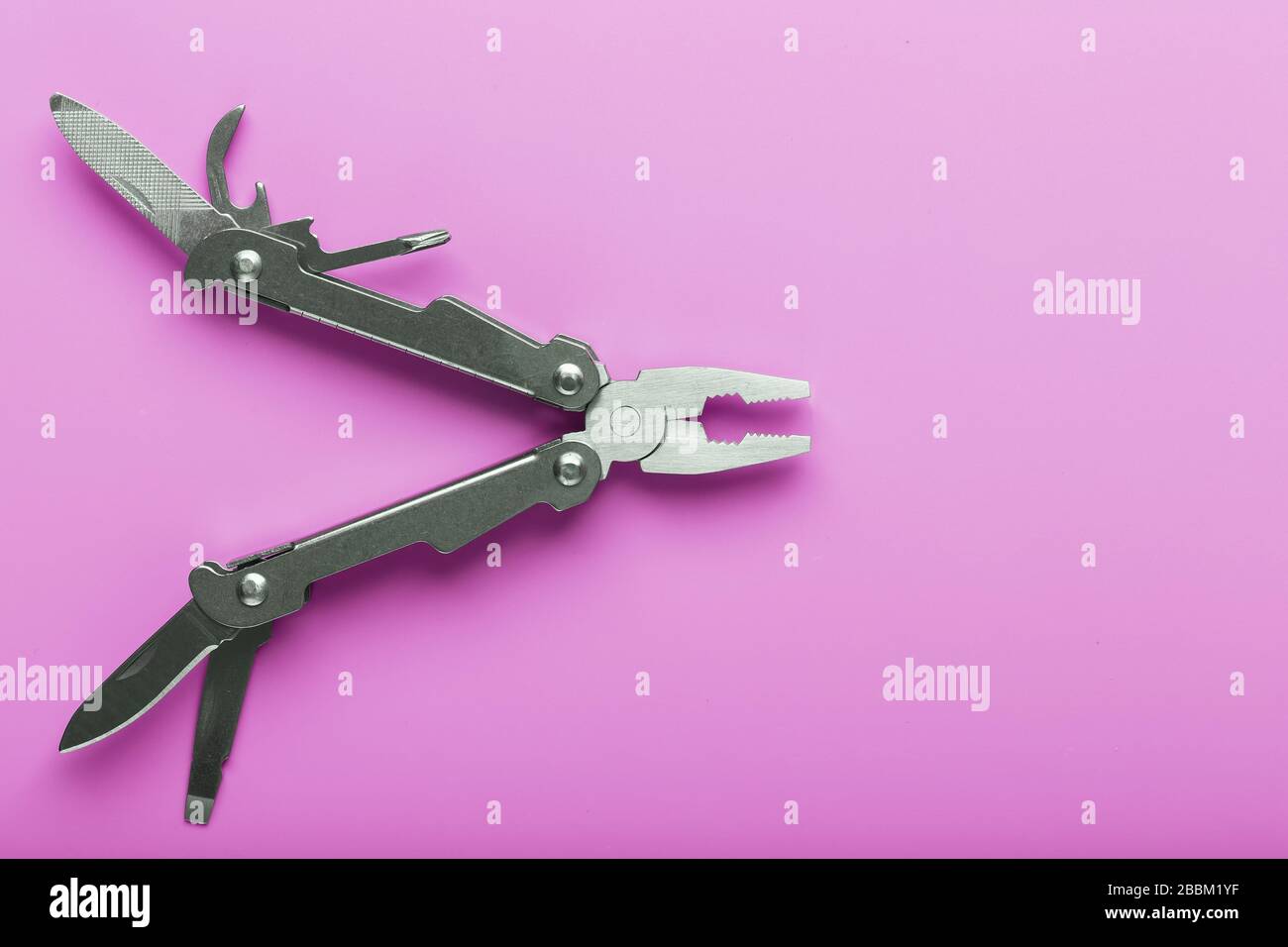 Multitool is a multi-functional tool on a pink background. The concept ...