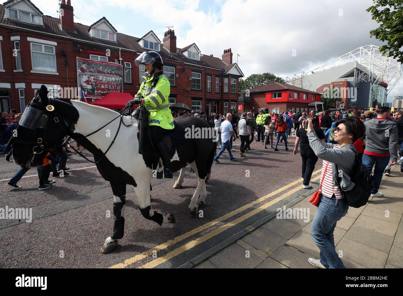 Police patrol the area surrounding Old Trafford as fans arrive Stock ...