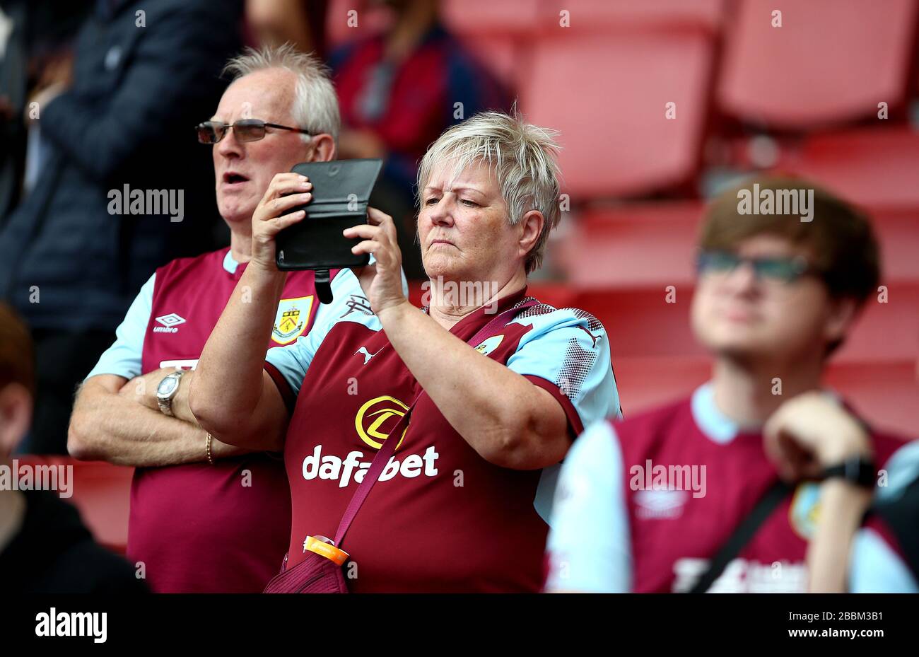 Burnley fans in the stands Stock Photo - Alamy
