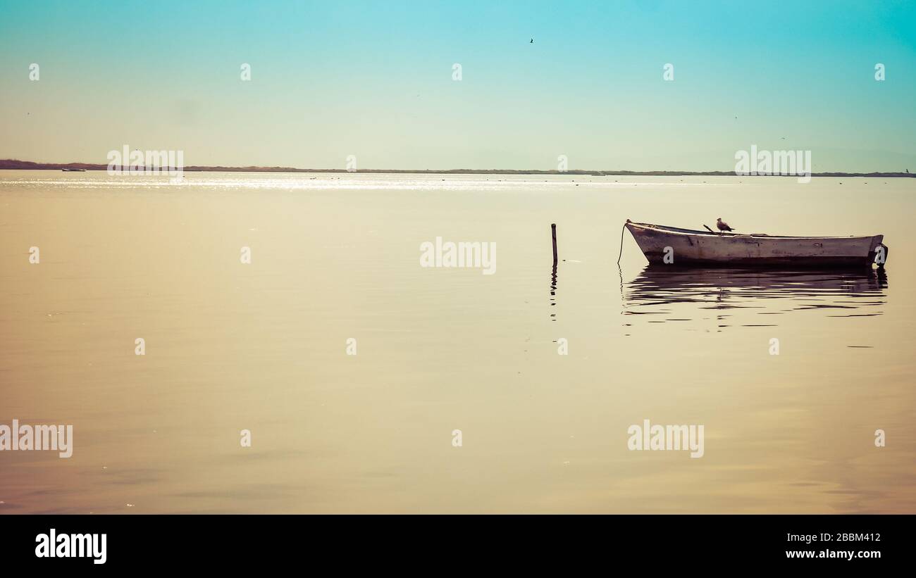 Small fishing boat floating on the sea water Stock Photo - Alamy