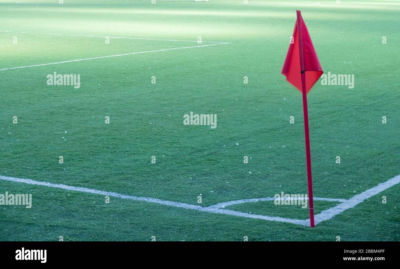 Soccer field with a corner red flag and flag pole Stock Photo - Alamy