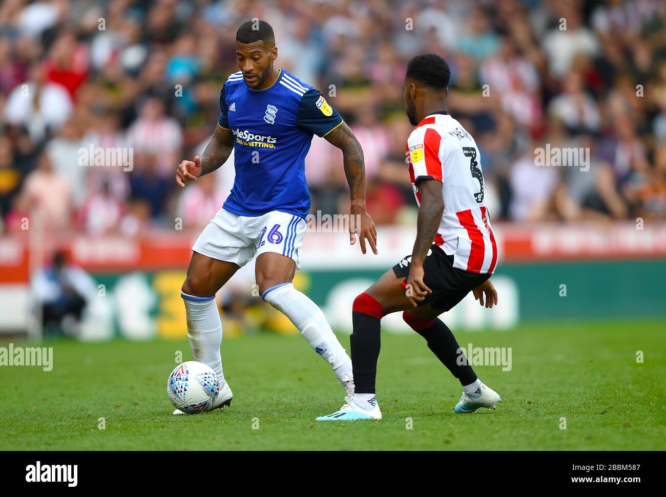 Birmingham City's David Davis (left) and Brentford's Rico Henry battle ...