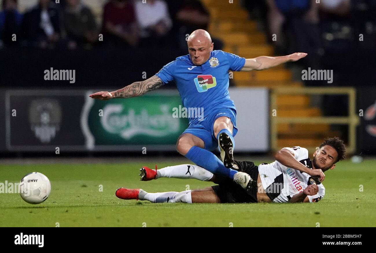 Notts County's Dion Kelly-Evans (right) makes a challenge on Stockport ...
