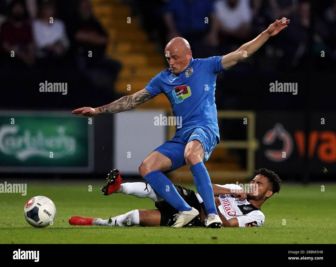 Notts County's Dion Kelly-Evans (right) makes a challenge on Stockport ...