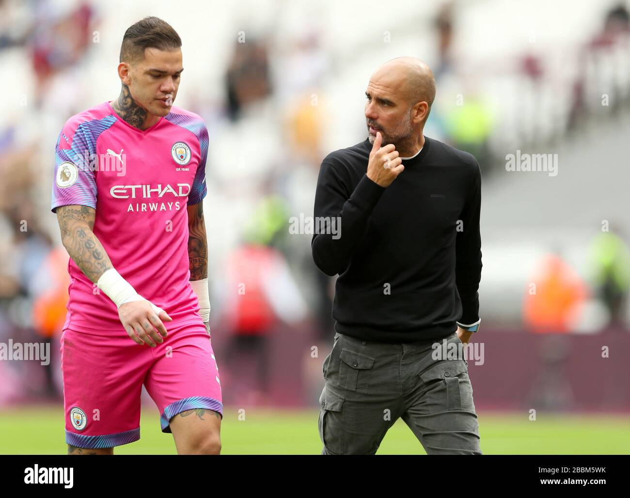 Manchester City goalkeeper Ederson (left) and Manchester City manager ...