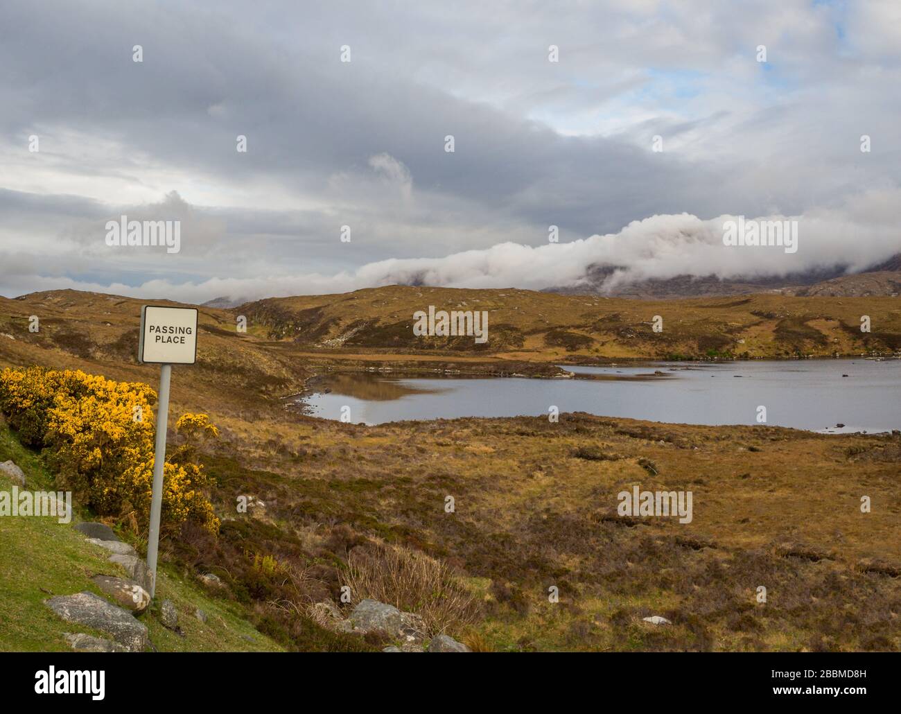 Passing Place sign by single track road overlooking a loch in the Outer ...