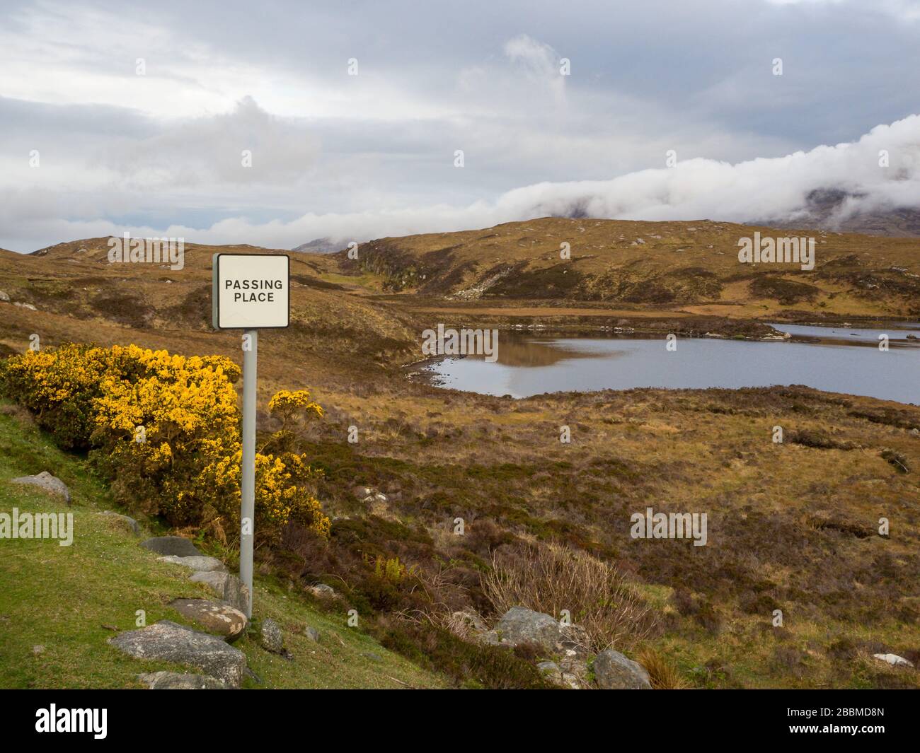 Passing Place sign by single track road overlooking a loch in the Outer ...