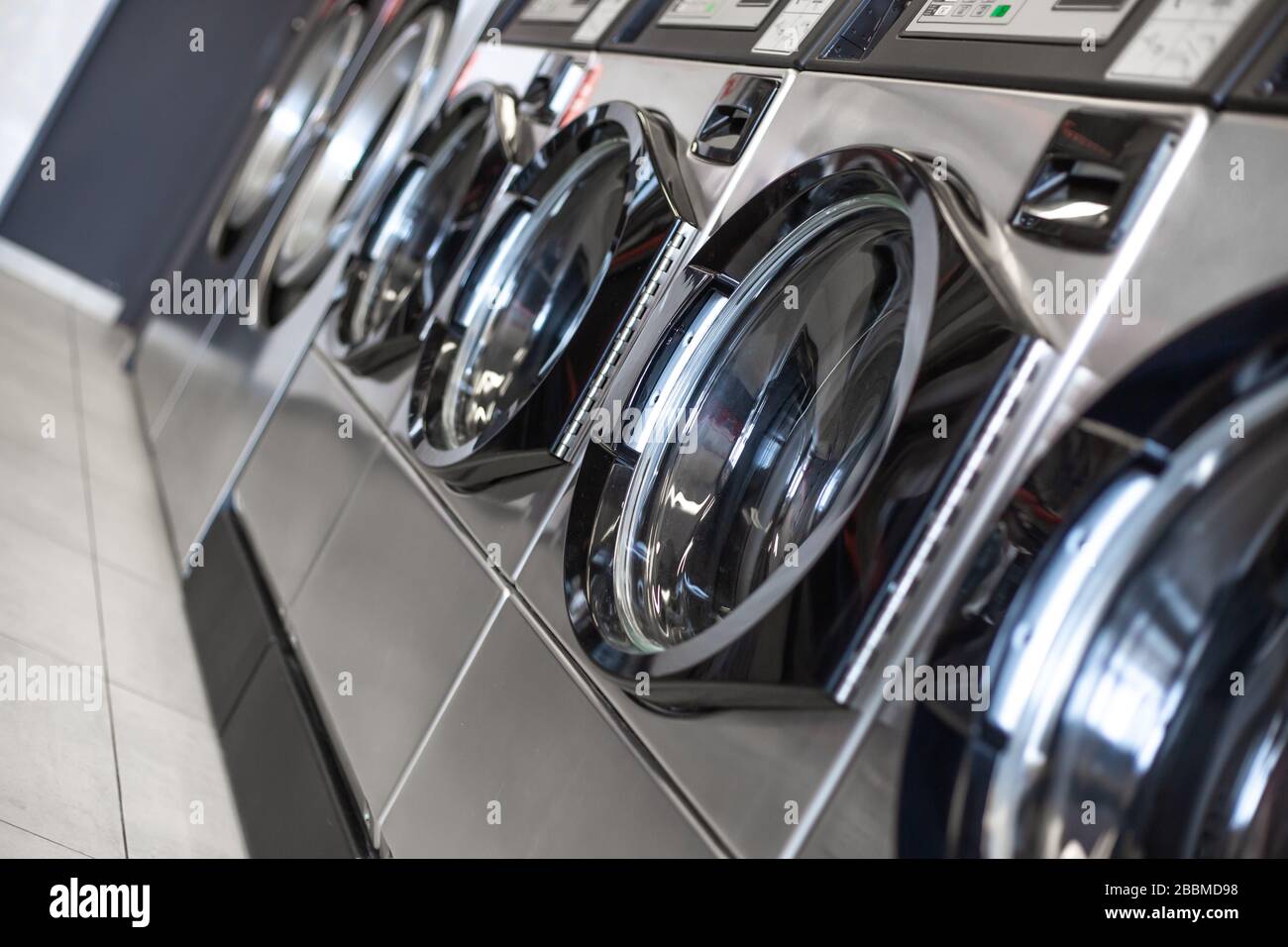 Close up of washing machines in a row in a laundry, ready to cleaning ...