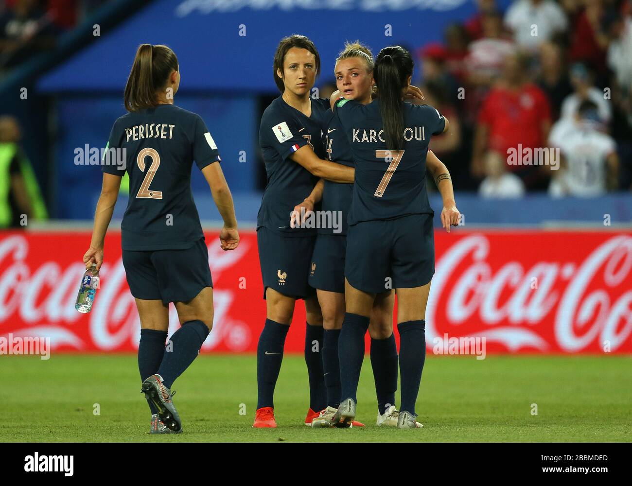 France's Marion Torrent (centre) is consoled by her team-mates after ...
