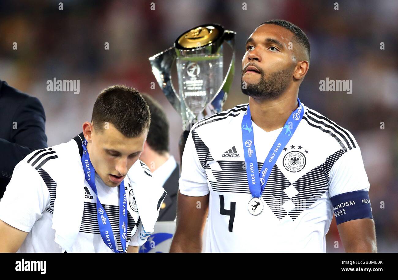 Germany U21's Jonathan Tah (right) appears dejected after collecting a ...