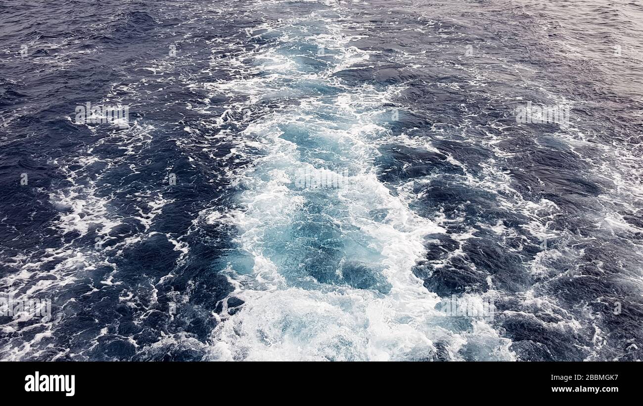Cruise ship or trail on the surface of the blue red sea. Sea water ship ...