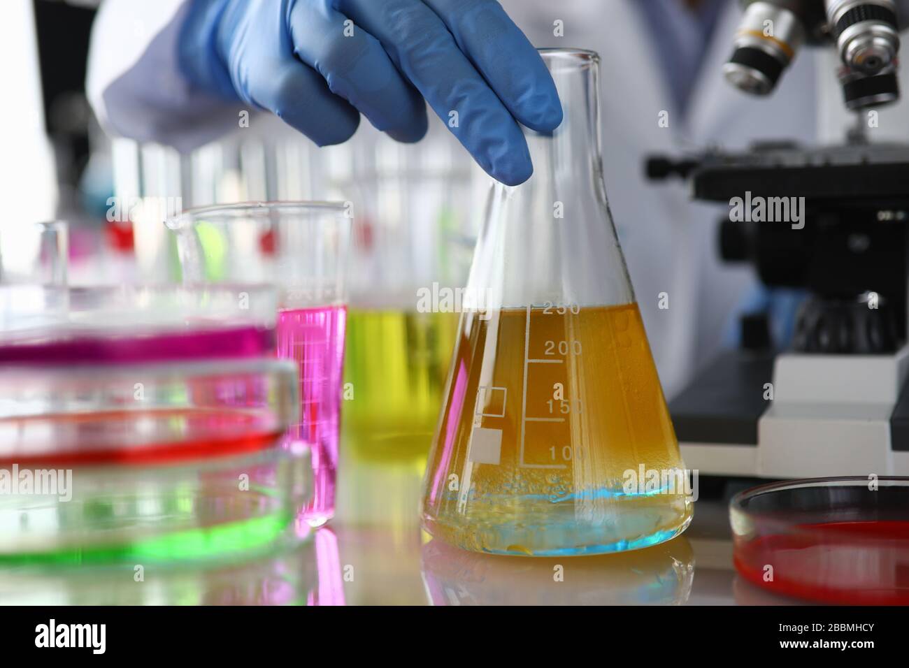 Scientist mixing chemical fluid Stock Photo - Alamy