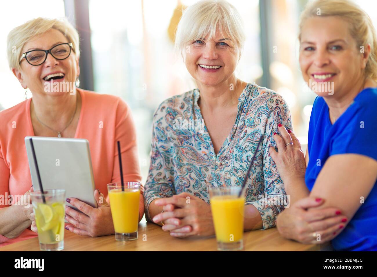Group of smiling senior women standing outside Stock Photo - Alamy