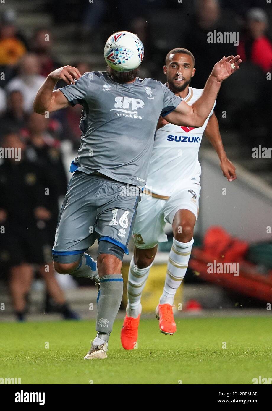 Milton Keynes Dons' Jordan Bowery (right) and Lincoln City's Michael ...